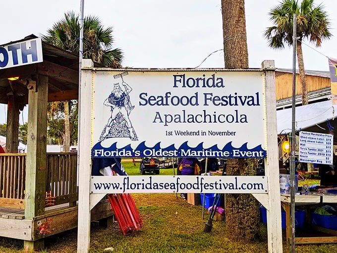 The Florida Seafood Festival sign promises a celebration where oyster shucking becomes an Olympic-worthy sport and seafood takes center stage.