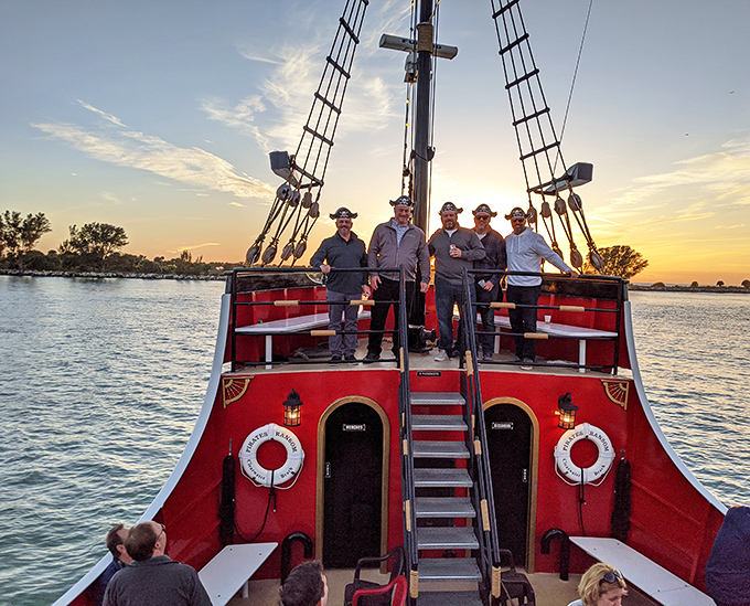 Crew members gather at the stern, their camaraderie as authentic as their commitment to creating unforgettable pirate adventures.