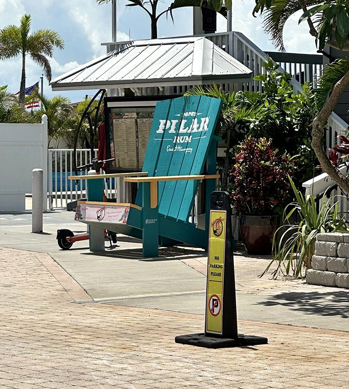 The oversized turquoise chair announcing "Pillar Rum"&mdash;because nothing says "tropical getaway" quite like furniture you need a ladder to climb into.