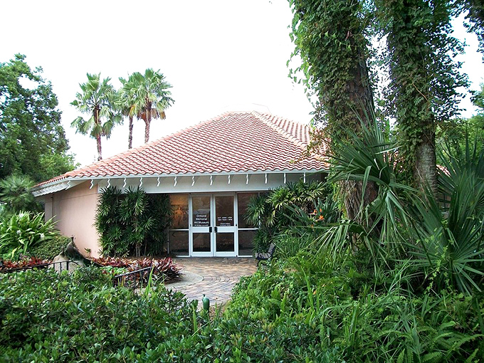 The museum entrance peeks through tropical foliage, like a cultural treasure waiting to be discovered by those who venture beyond the beach.