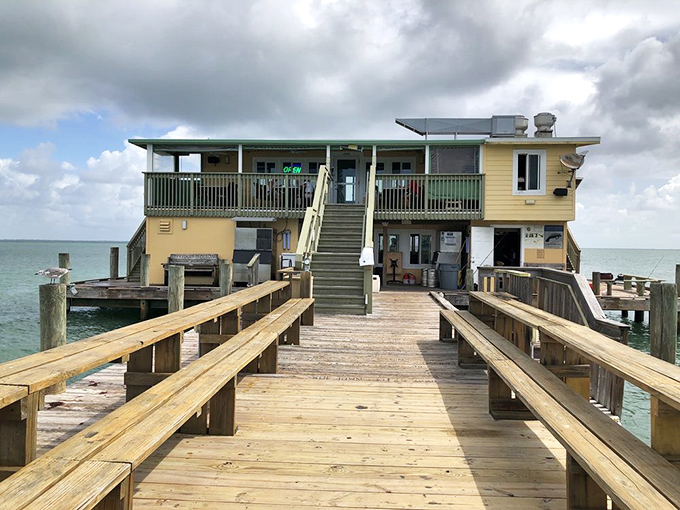 The two-story restaurant seems to float above the water, a yellow and green beacon of Old Florida charm.