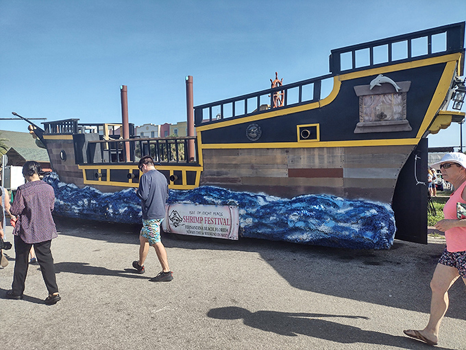A magnificent pirate ship display celebrates the island's swashbuckling history, complete with painted waves that seem to carry it through the festival crowds.