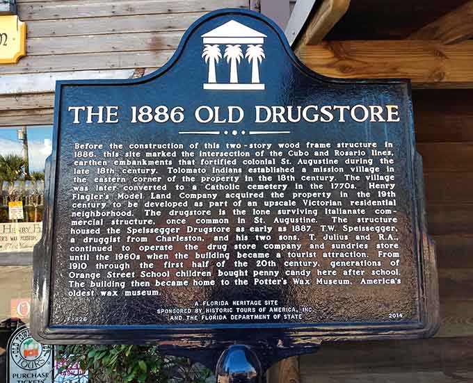 This historical marker tells the building's origin story, because even wax museums deserve their own backstory, preferably one involving old-timey drugstores.