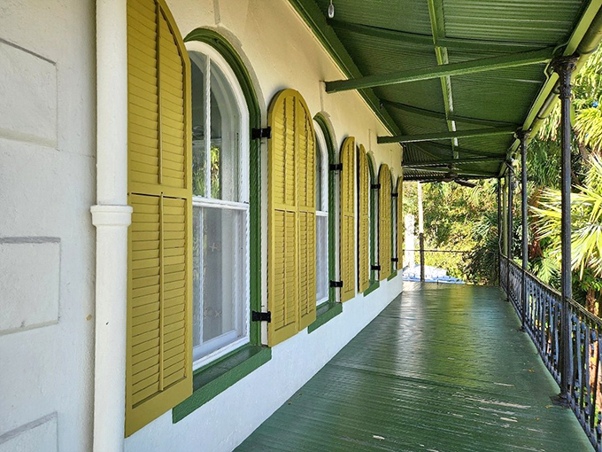 The distinctive yellow shutters and wrap-around balcony capture the essence of Key West's architectural charm.