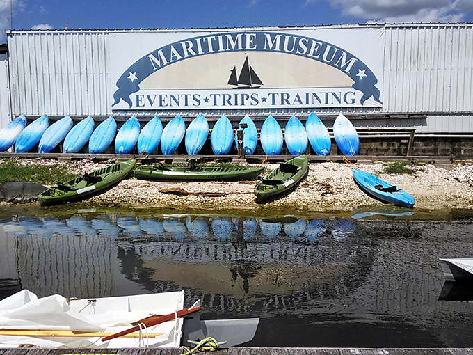 A rainbow of kayaks stands ready outside the museum's training facility, promising adventures for paddlers of all skill levels.