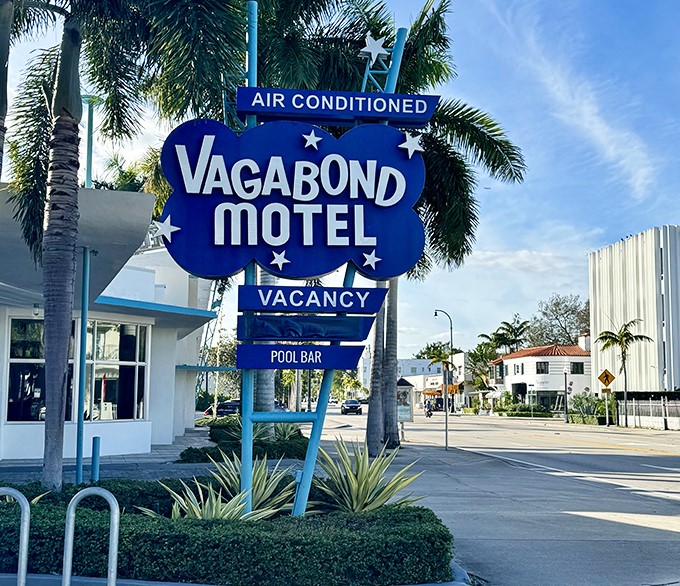 That iconic blue cloud with twinkling stars announces "AIR CONDITIONED" with vintage enthusiasm &ndash; a neon beacon of mid-century hospitality.