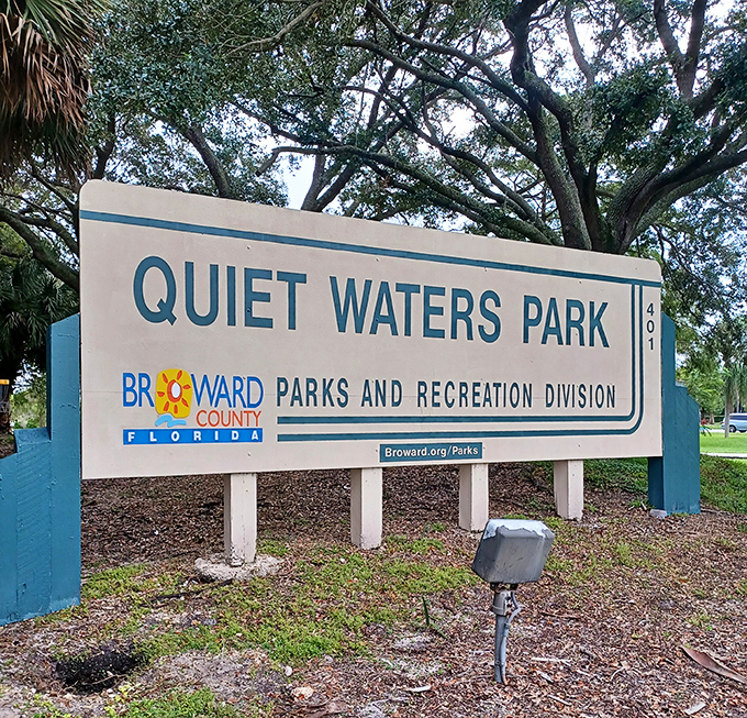 The unassuming entrance sign that marks the boundary between ordinary suburban life and a 430-acre recreational wonderland waiting to be explored.