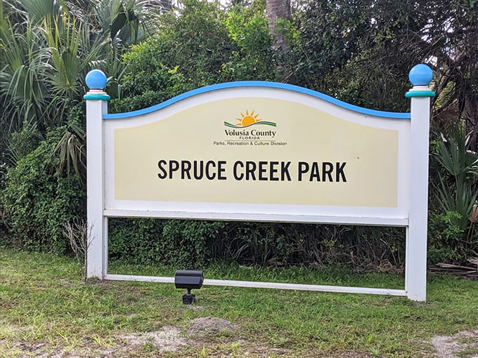The park sign welcomes visitors to Spruce Creek, marking the entrance to adventures that don't require passports or plane tickets.