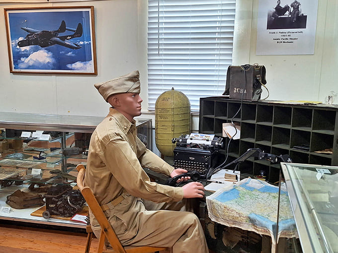 A WWII-era office display recreates the administrative side of war, complete with period-appropriate desk, typewriter, and maps that guided crucial military decisions across multiple theaters.