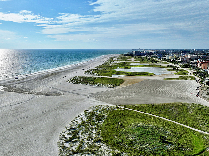 An aerial view reveals Treasure Island's remarkable width, where expansive white sands meet the turquoise Gulf in a stunning coastal panorama.