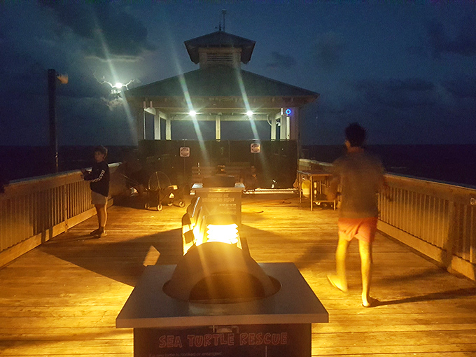 Night transforms the pier into a magical gathering place where fire pits glow and conversations flow under star-studded skies.