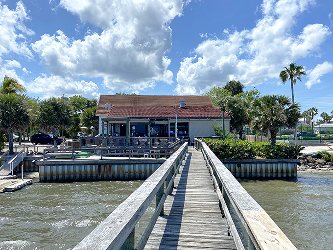 A wooden walkway leads to seafood nirvana, with palm trees standing guard over this unassuming temple of garlic and butter.