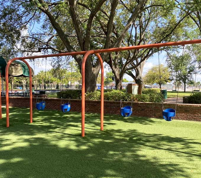 These bright blue swings invite children to touch the sky, their laughter providing the perfect soundtrack to lazy Florida afternoons.