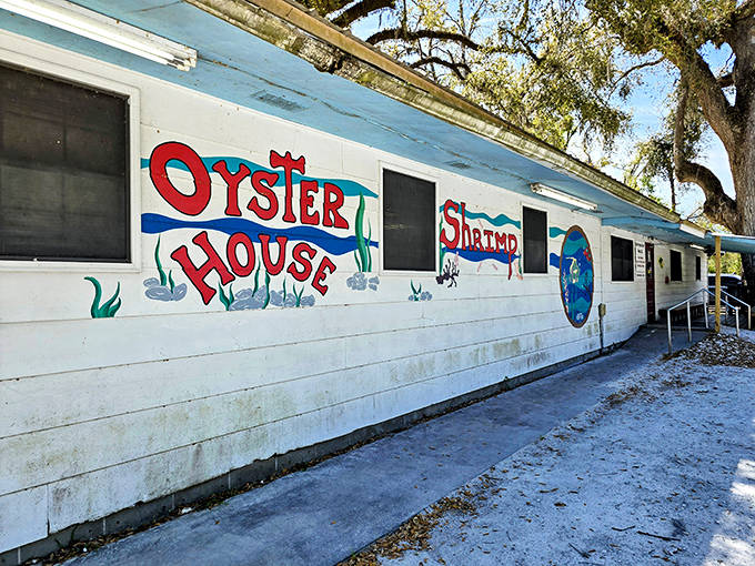 The unassuming exterior of Deal's Famous Oyster House, where hand-painted signs promise seafood treasures within. No fancy facade needed when the food speaks volumes.