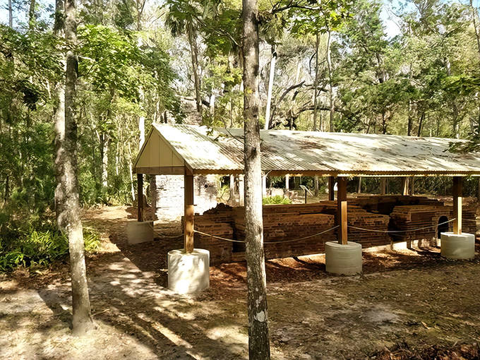 Rustic wooden shelter protecting ancient brick foundations &ndash; where Florida's sweet history began among towering pines and whispering palms.