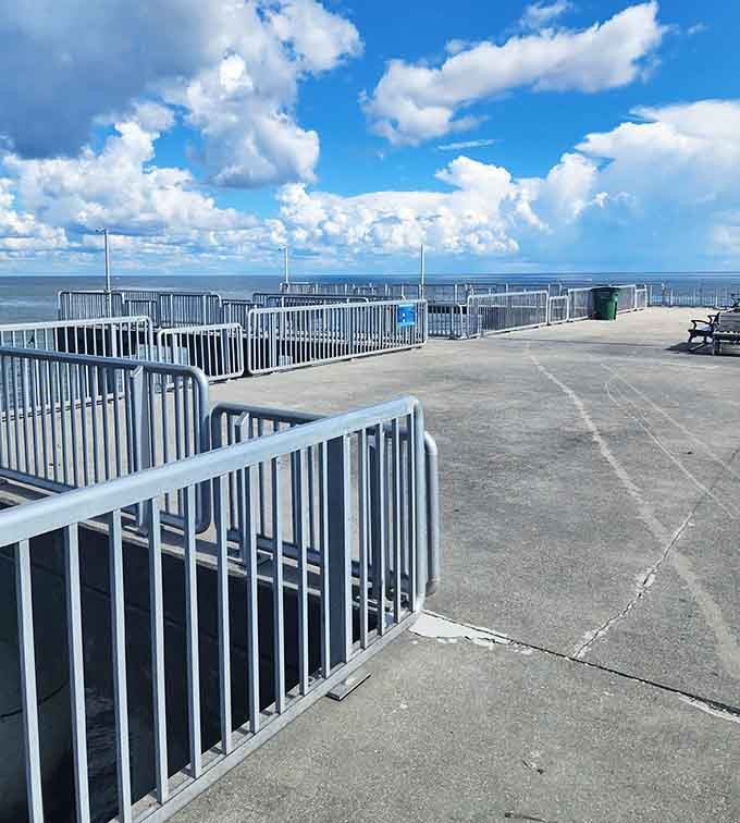 The Cedar Key Fishing Pier stretches into calm waters under a sky full of puffy clouds.