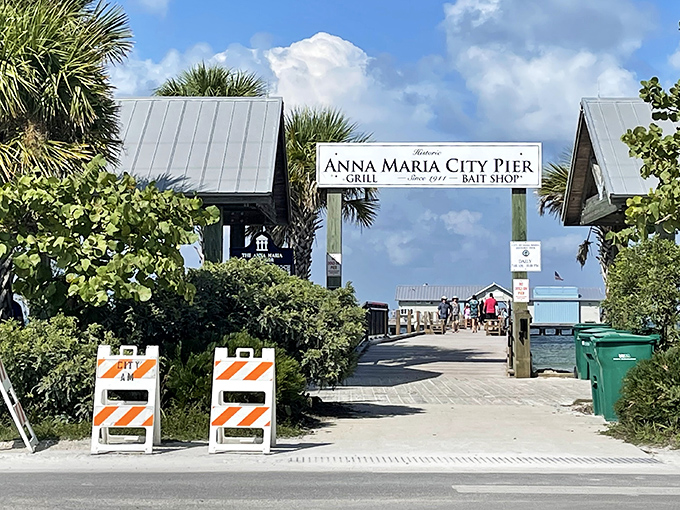 The welcoming entrance to Anna Maria City Pier invites explorers to venture over turquoise waters for fishing, dining, and dolphin-spotting adventures.