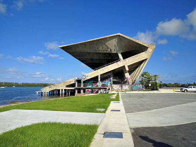 Once home to roaring crowds and speedboat races, the Marine Stadium now stands as a silent sentinel over Biscayne Bay, its angular design still impressive decades later.
