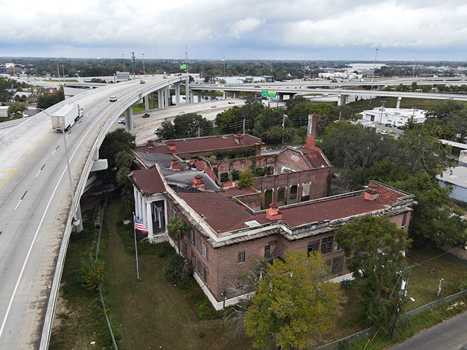 Modern highways rush past this frozen moment in time, thousands of daily commuters missing the historical treasure hiding in plain sight beside the interstate.