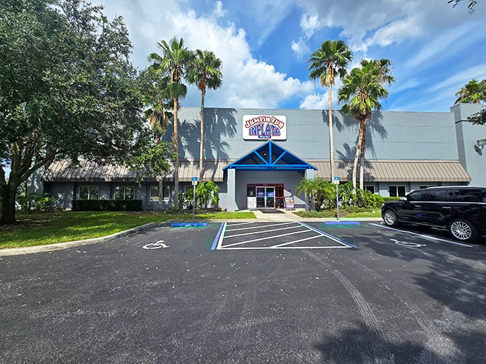 Palm trees welcome visitors to Jumpin Fun Inflata Park's exterior, where Florida sunshine gives way to indoor bouncing bliss.