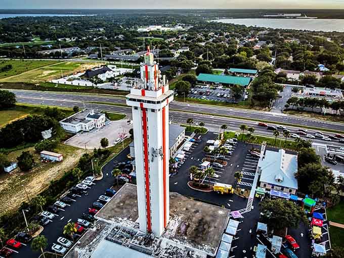 High Aerial View: From above, the tower commands attention like an exclamation point on the landscape, surrounded by the sprawling development that has replaced many of the original citrus groves.