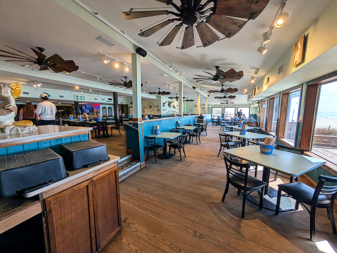 Rustic charm meets coastal cool in this dining room where ceiling fans spin stories of countless beach days and memorable meals.