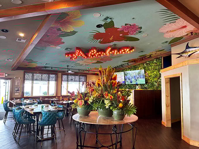 Tropical vibes overflow from the ceiling down, with vibrant florals and that "Aloha" sign promising you're now officially on island time.