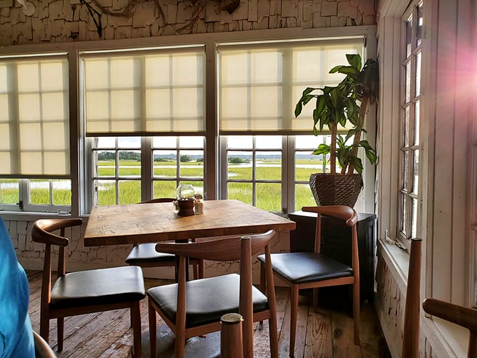 Sunlight streams through windows framing the verdant marsh, turning this simple wooden table into the best seat in St. Augustine.