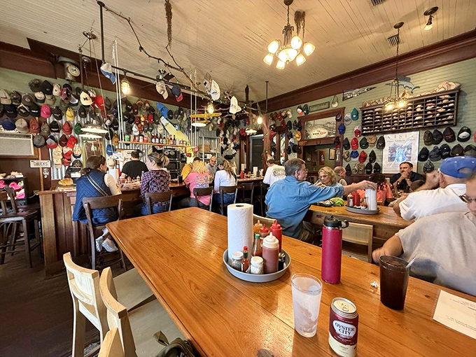 Baseball caps from decades past create a colorful canopy above diners enjoying the day's freshest catches.