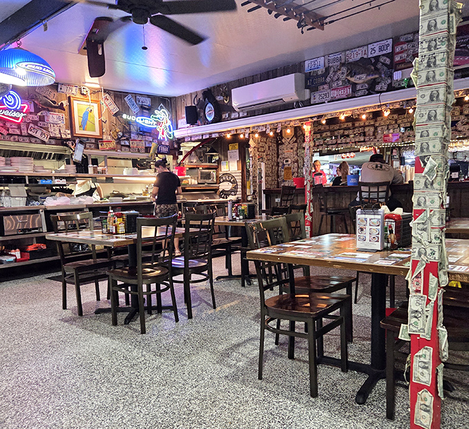 Dollar bills wallpaper every surface like a currency museum gone wild, each one telling a story of satisfied diners past.