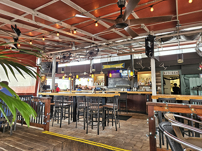 String lights and ceiling fans create the perfect Florida dining atmosphere where casual meets festive under an open-air canopy that welcomes the breeze.
