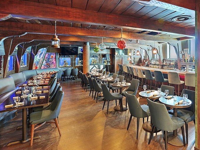 Dining inside what feels like a luxurious sunken galleon, complete with wooden beams and ambient lighting that mimics the mysterious depths of the ocean.