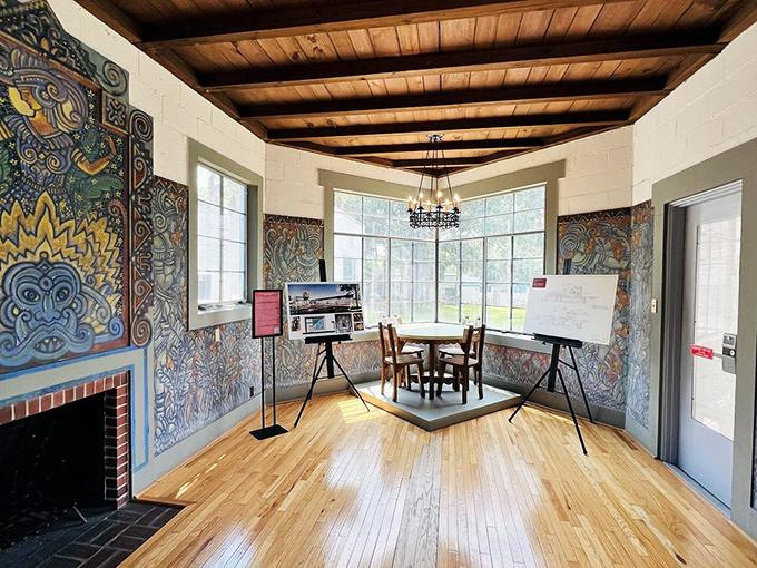 A kaleidoscope of color dances across walls where wooden beams frame artistic visions that whisper of creative ghosts.