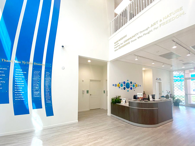 Sunlight streams through the modern lobby where art and nature's mission statement floats above, setting the tone for exploration.