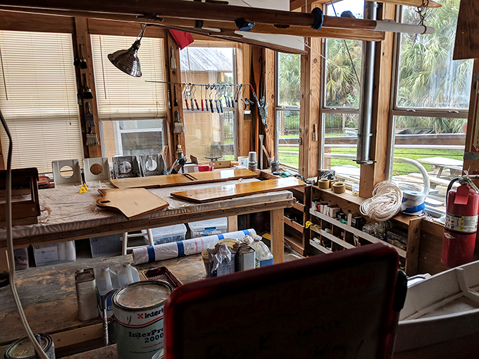 Sunlight streams through windows illuminating the workshop where traditional boatbuilding techniques are preserved through both practice and teaching.