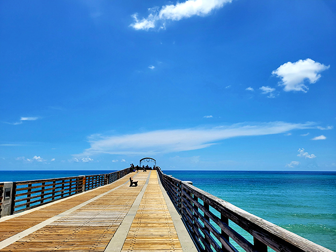 The wooden path beckons visitors to stroll nearly a thousand feet above turquoise waters, with every step revealing new ocean vistas.