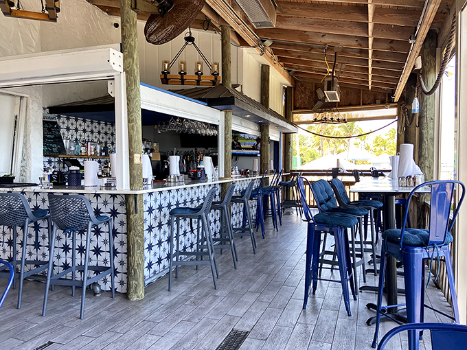 Interior: Nautical charm meets casual comfort in this waterfront dining room where blue chairs invite you to settle in for a seafood adventure.