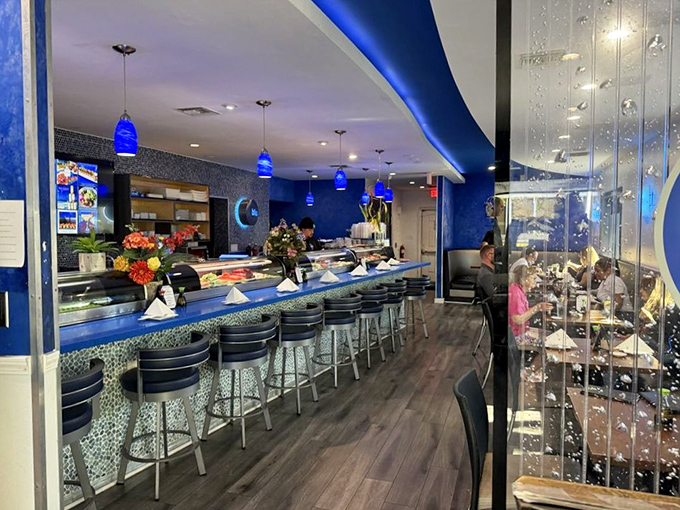 Step into an underwater fantasy where blue mosaic tiles shimmer like sun-dappled waves and pendant lights cast a cool glow that makes everyone look vacation-refreshed.