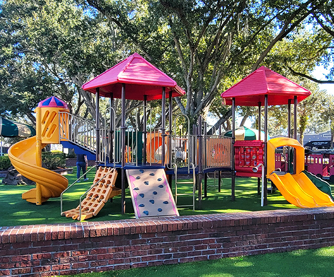 The playground area features colorful equipment for all ages, with that magical rubber surface that has saved countless childhood knees from scrapes.