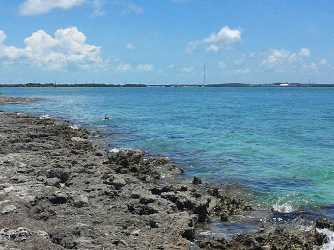 Nature's reclamation project in full display &ndash; rocky shores and crystal waters create a stunning natural boundary.
