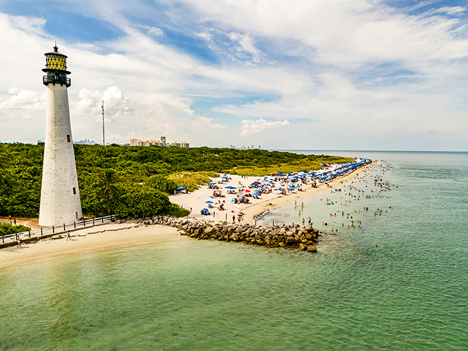 The beach at Bill Baggs Cape Florida State Park offers pristine swimming conditions with Miami's skyline visible in the distance.