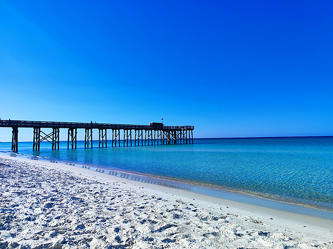 The sugar-white sands of St. Andrews State Park meet the emerald waters of the Gulf, creating Florida's signature beach scene.