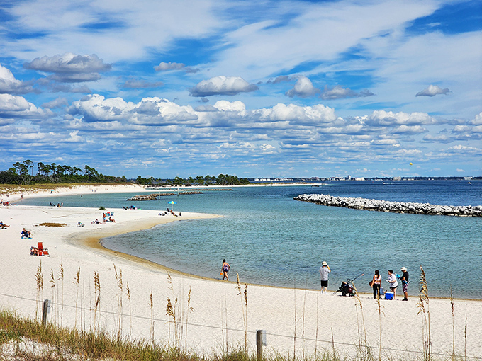 Beachgoers enjoy the perfect conditions at St. Andrews State Park, where the clear water and white sand create a tropical paradise.
