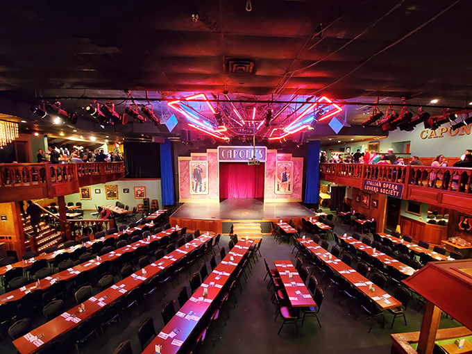 Inside Capone's Dinner Show, tables surround a central stage where flappers and gangsters transport diners to the Roaring Twenties during this immersive meal experience.