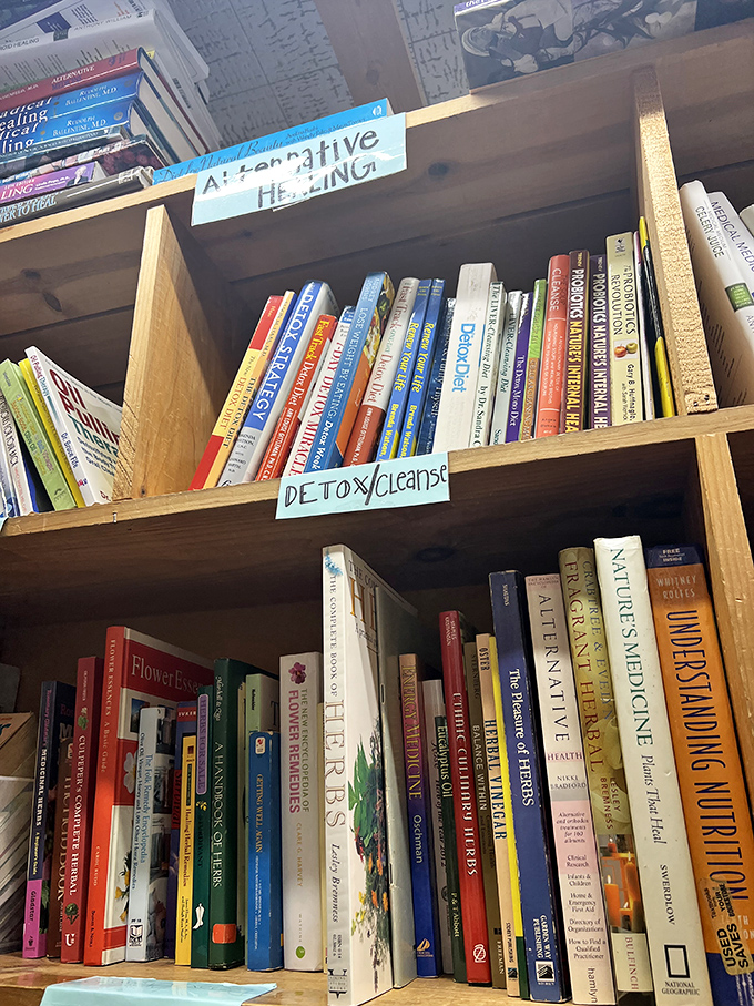 Alternative healing books line these shelves, offering cures for everything except the condition of wanting too many books.