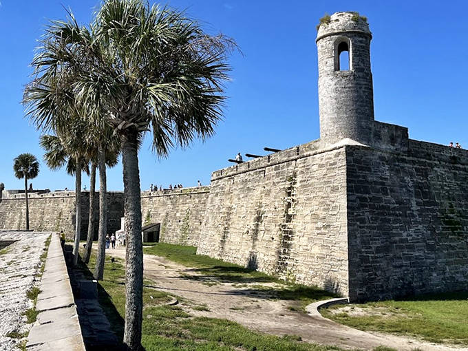 Ancient watchtowers and weathered walls tell stories of centuries gone by, while palm trees add that distinctly Florida touch to European military architecture.