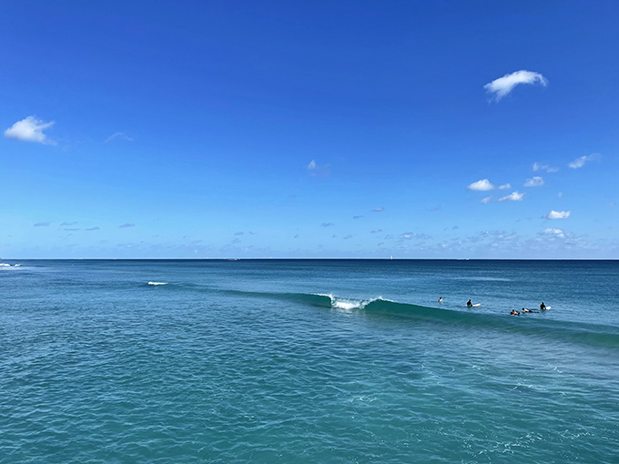 Surfers catch perfect waves near the pier, where the Atlantic offers ideal conditions for both pros and beginners.