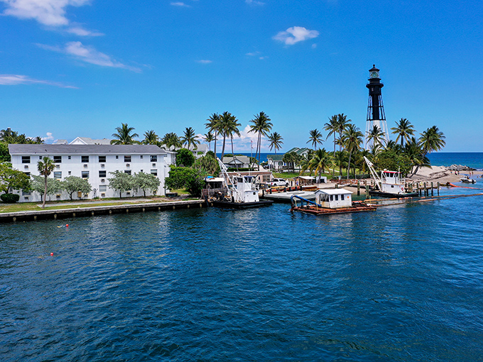 Maritime charm in full display as boats bob gently beside the lighthouse, creating that "I should probably quit my job and live here" feeling we all secretly crave.
