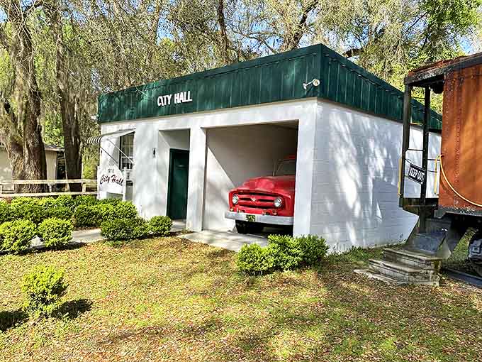 Check out this unique vintage City Hall, featuring a classic red fire truck tucked neatly inside the open garage.