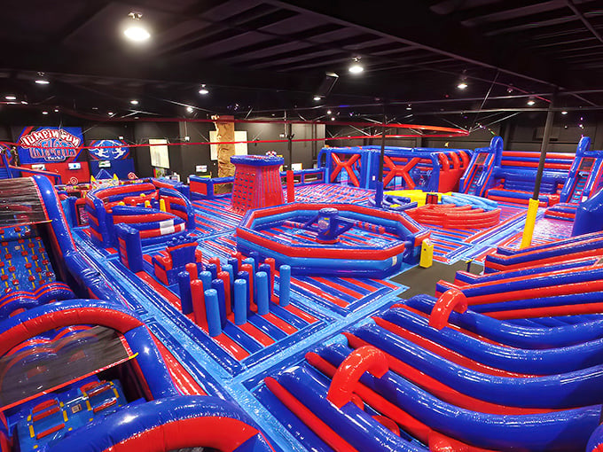 The park's signature red and blue obstacle courses create a labyrinth of inflatable challenges that would make even Olympic athletes giggle.